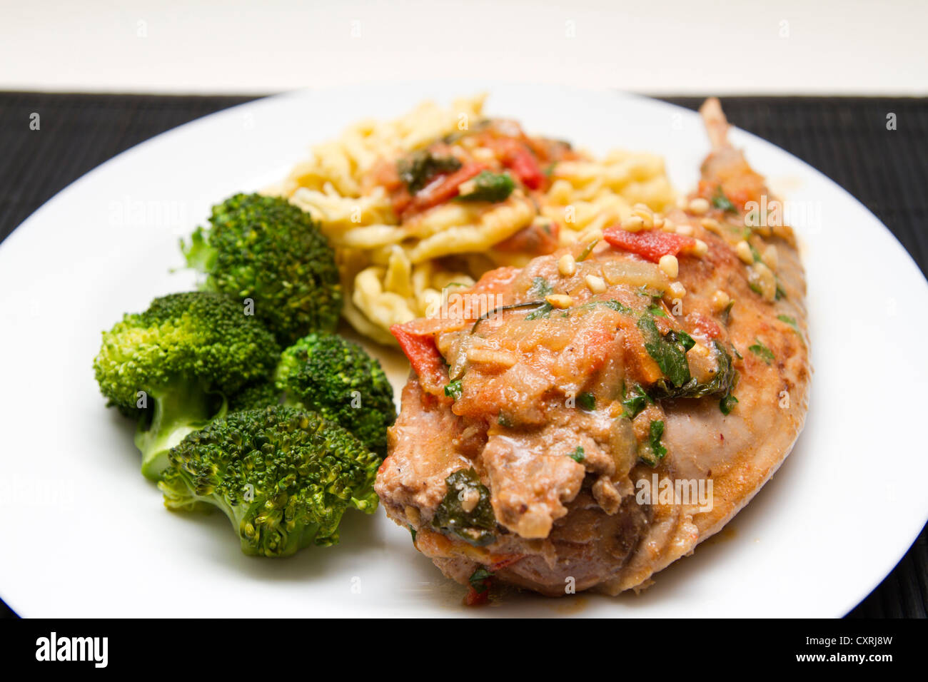 Braised rabbit with noodles and broccoli Stock Photo - Alamy