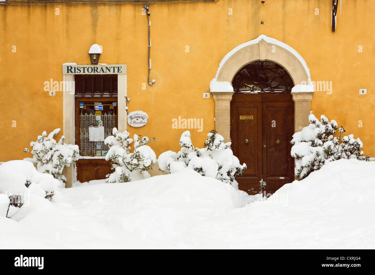 Snow-covered restaurant entrance in Pienza, Tuscany, Italy, Europe ...