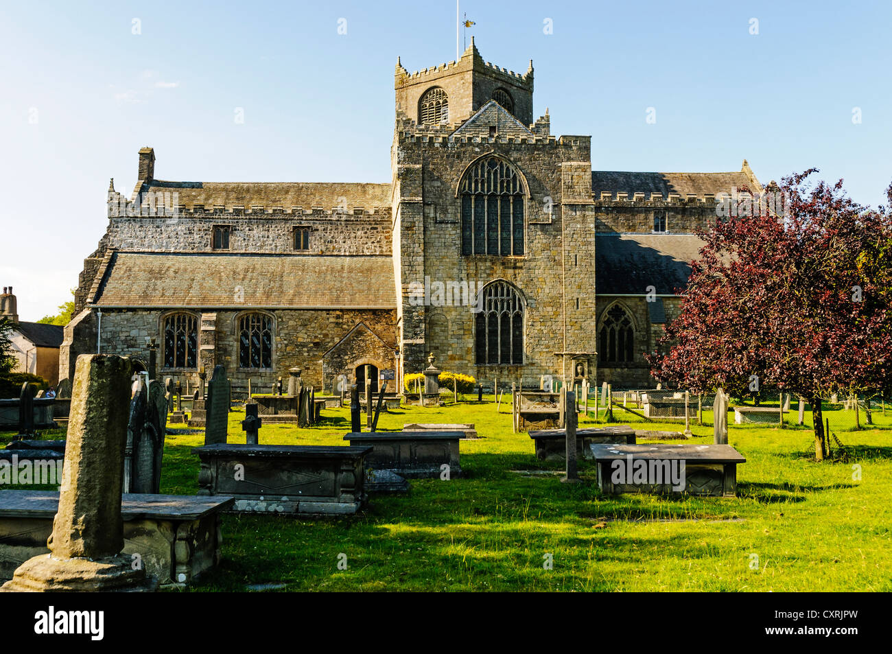 The late afternoon sun shines on Cartmel parish church (Cartmel Priory ...