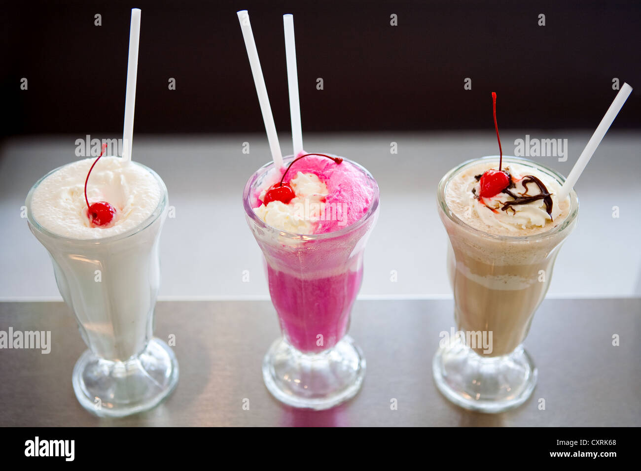 3 Milkshakes sit of a ice cream parlor counter Stock Photo - Alamy