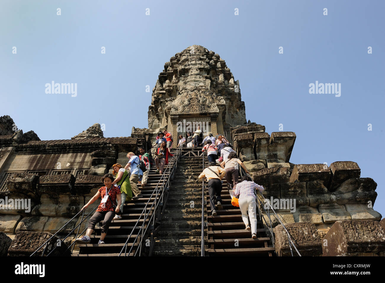 Tourists climbing a steep staircase, Angkor Wat temple, Cambodia, South ...