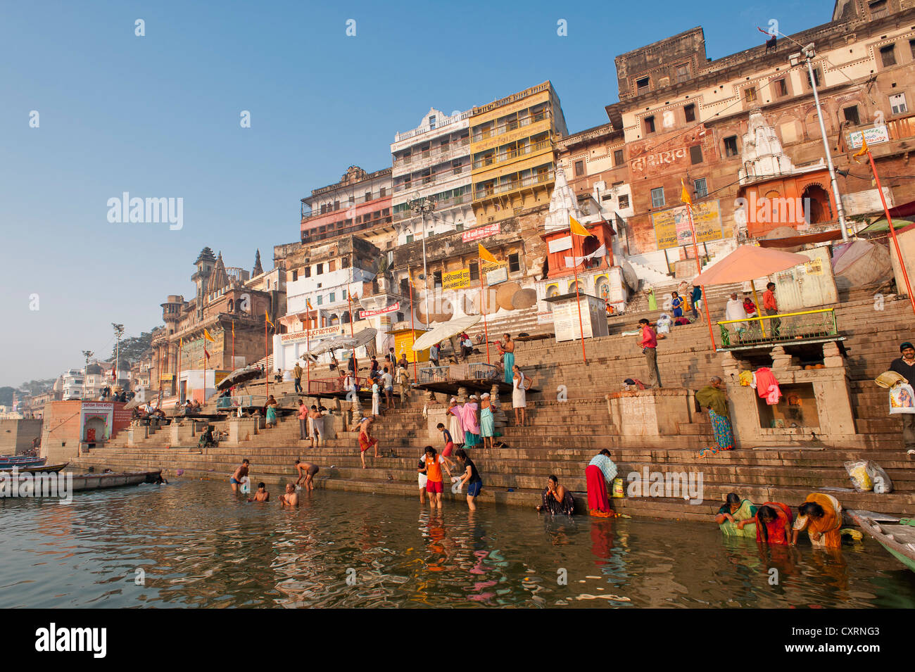 Bathers, boats, Ghats, holy stairs leading to the Ganges, city view in ...