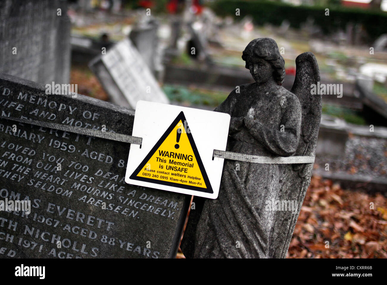 Warning sign on an unsafe headstone in Tottenham cemetery, London Stock ...