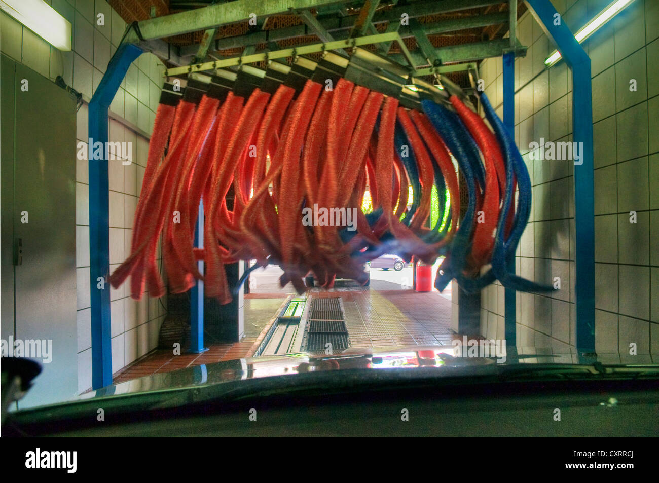 View from the driver's seat into a running car wash with textile ...