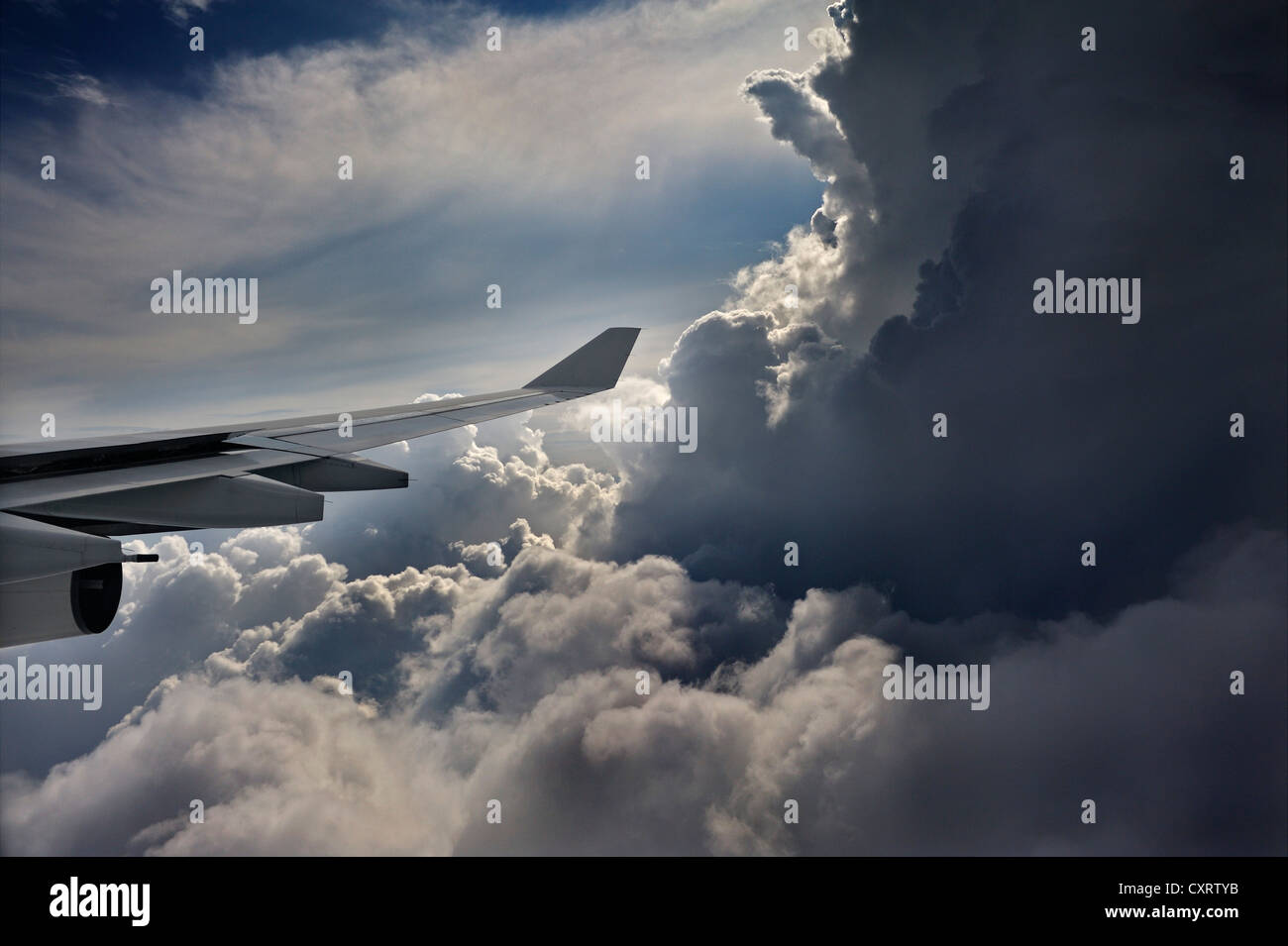 Wing of an airplane with dramatic cloud formations Stock Photo - Alamy