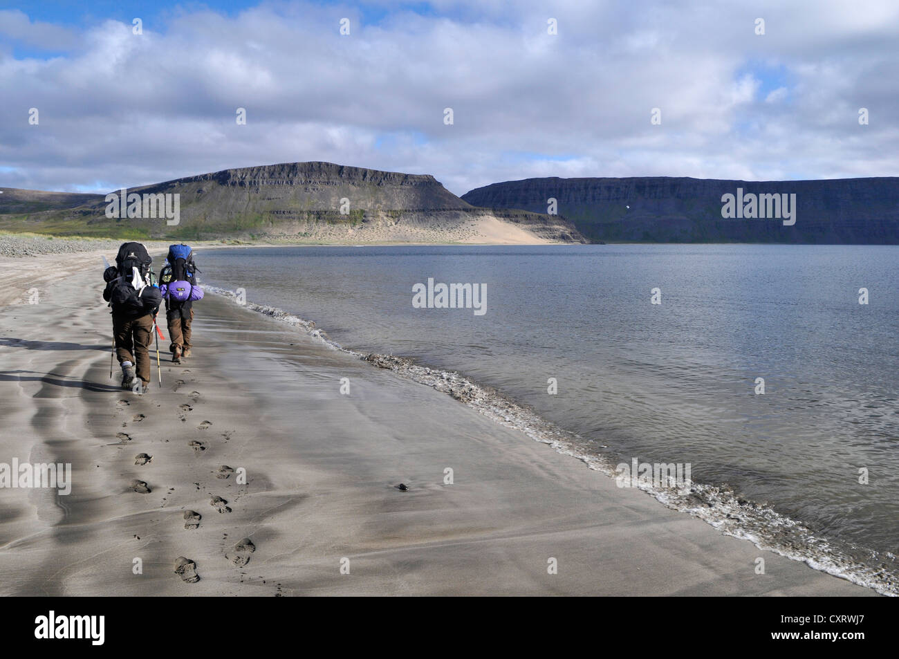 Hikers walking on the beach, A alvík Bay, Adalvik, Hornstrandir ...