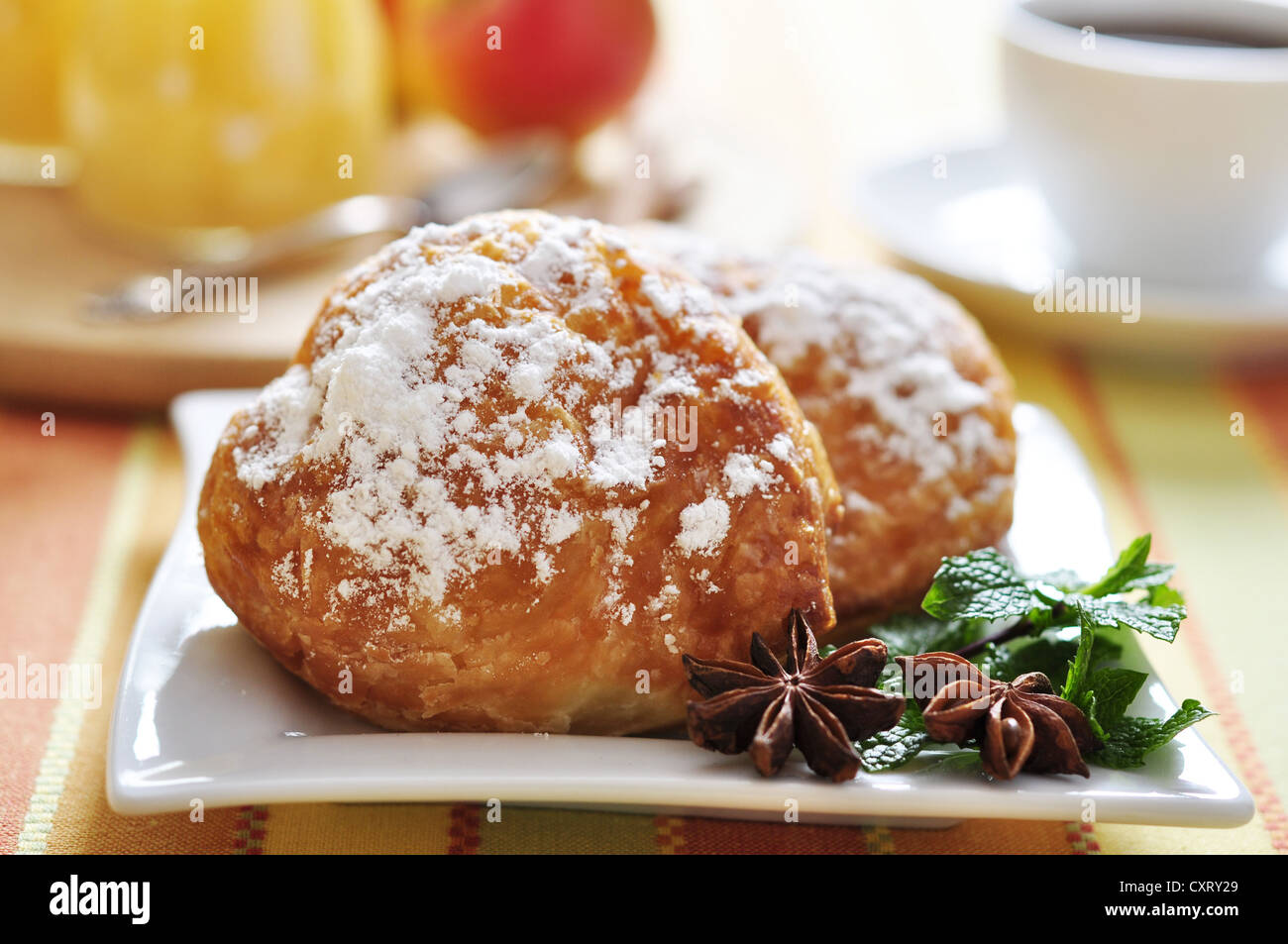 Two buns with apple stuffing on plate with mint closeup. Small shallow ...