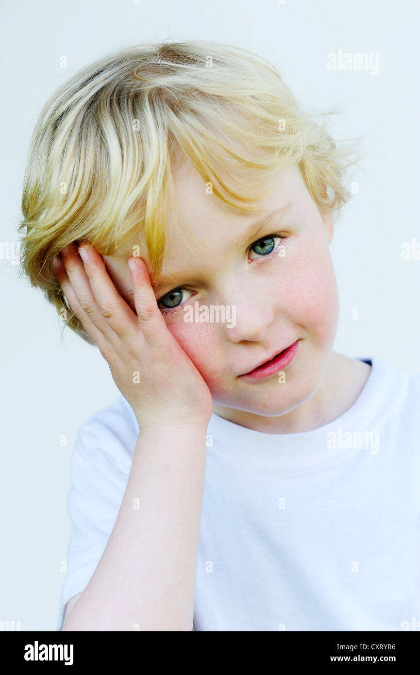 Small boy with his hand on his head Stock Photo - Alamy