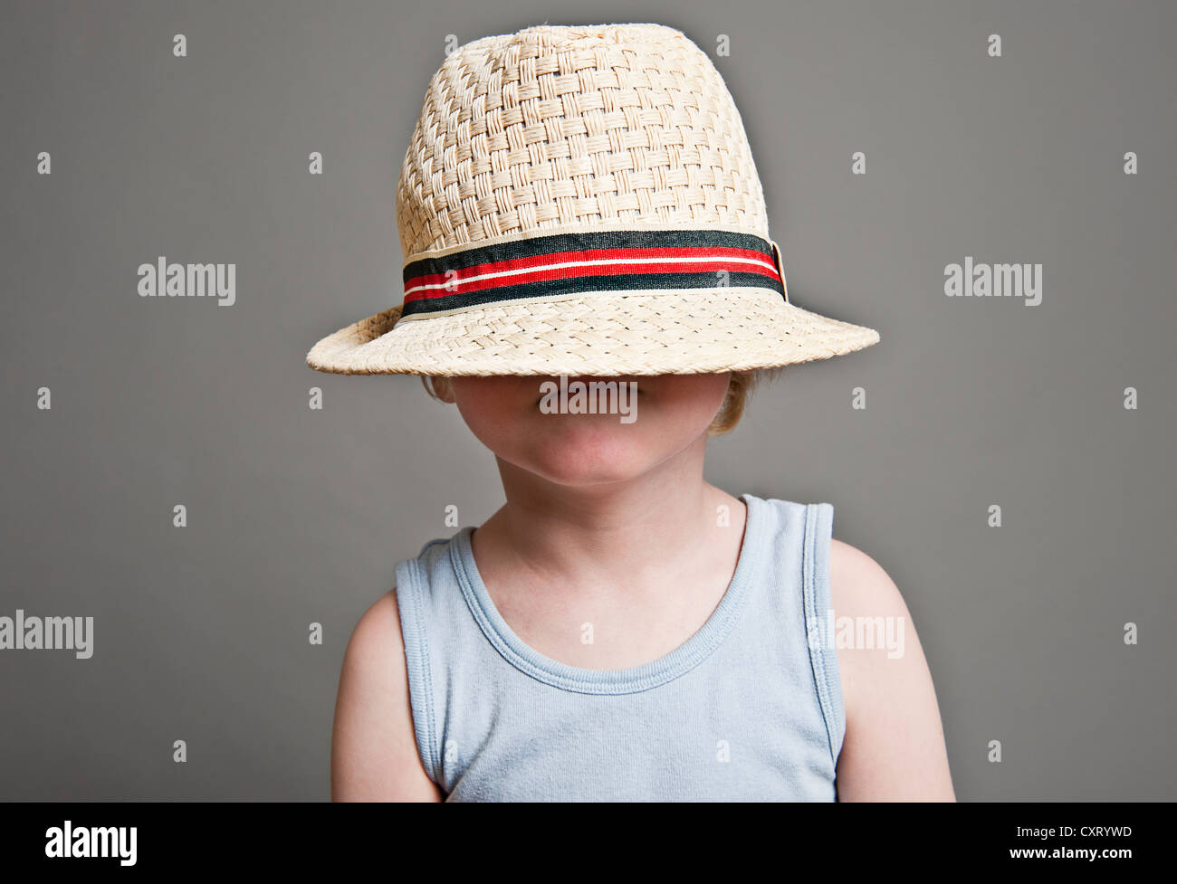 Little boy with large straw hat pulled over his head Stock Photo - Alamy