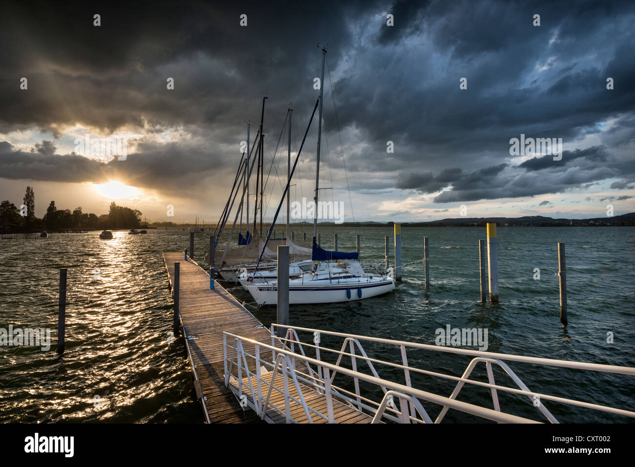 Sailing yacht, thunderstorm clouds at the back, harbour of Iznang ...