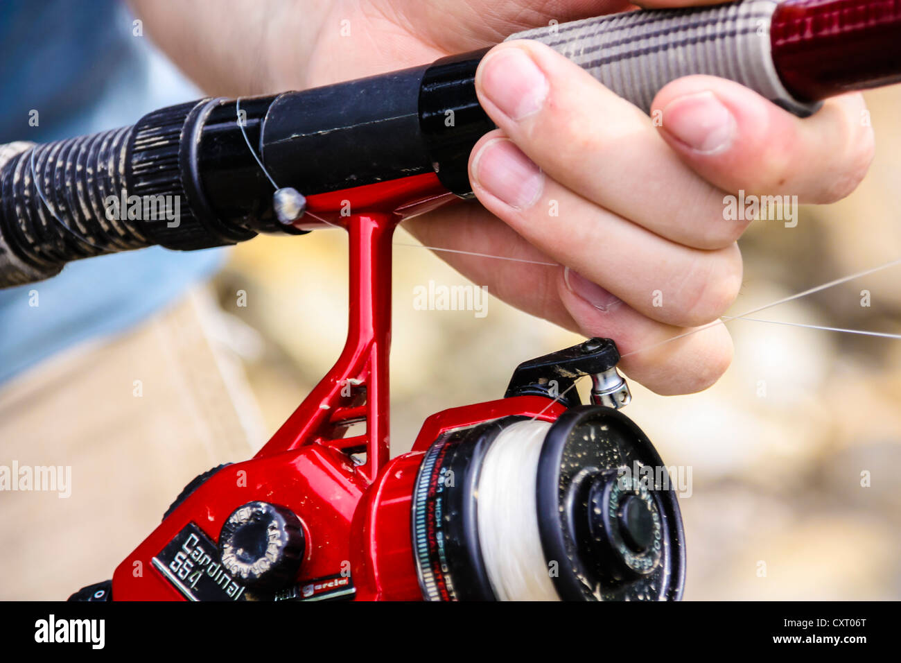 Hand holding fishing pole hi-res stock photography and images - Alamy