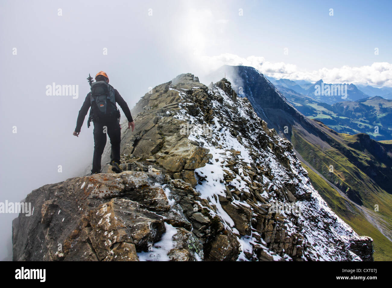 Mountain climber walking on the ridge leading to Gsuer, Adelboden ...