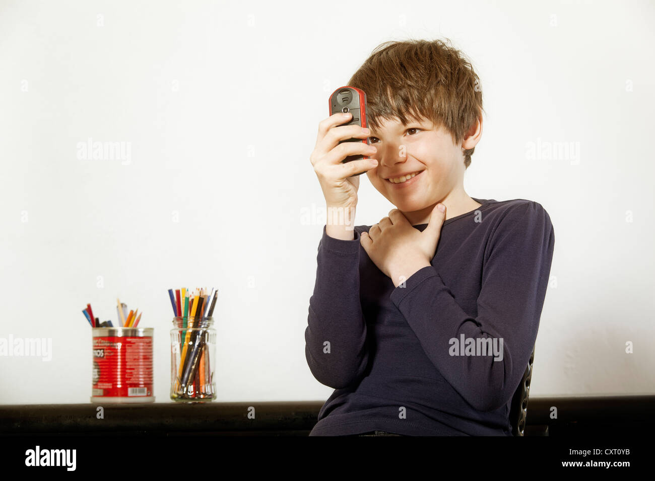 Boy playing with the camera of a mobile phone Stock Photo - Alamy
