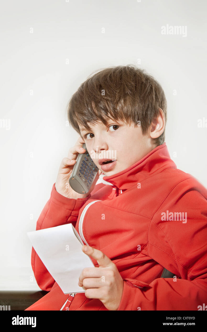 Boy speaking on a cordless phone Stock Photo - Alamy