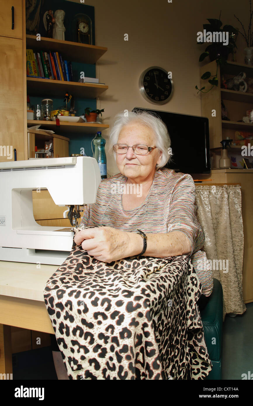 Old woman working on a sewing machine Stock Photo - Alamy