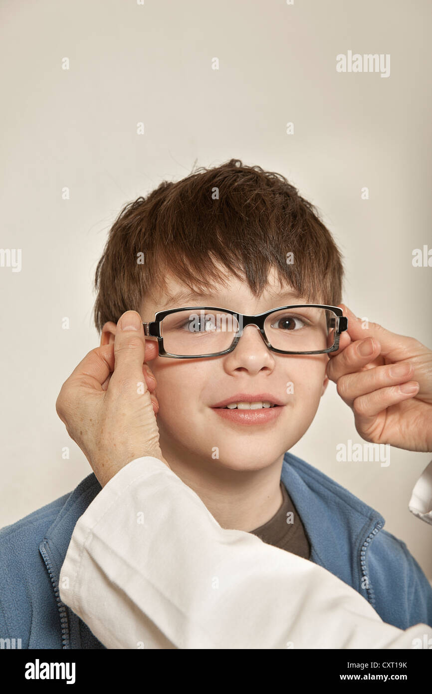 Boy trying on glasses Stock Photo - Alamy