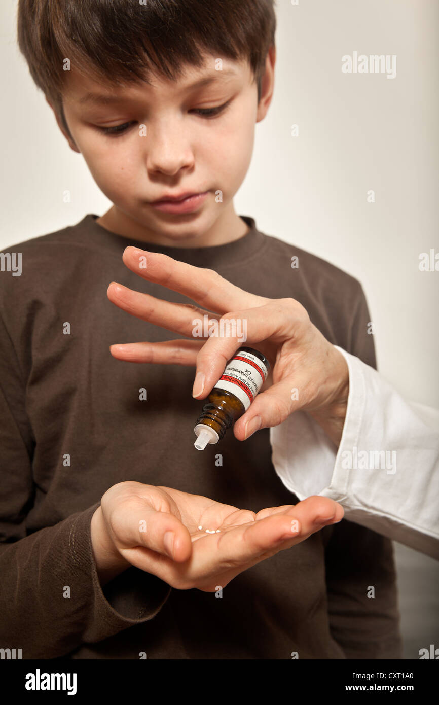 Boy being given globules Stock Photo - Alamy