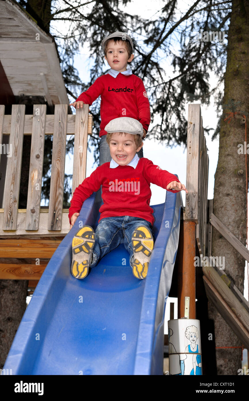 Boy in cap slide in playground boys hi-res stock photography and images ...