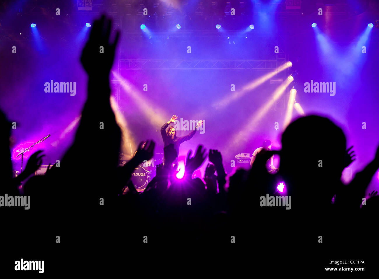 Visitors of the open-air festival cheering for the Swiss pop band ...