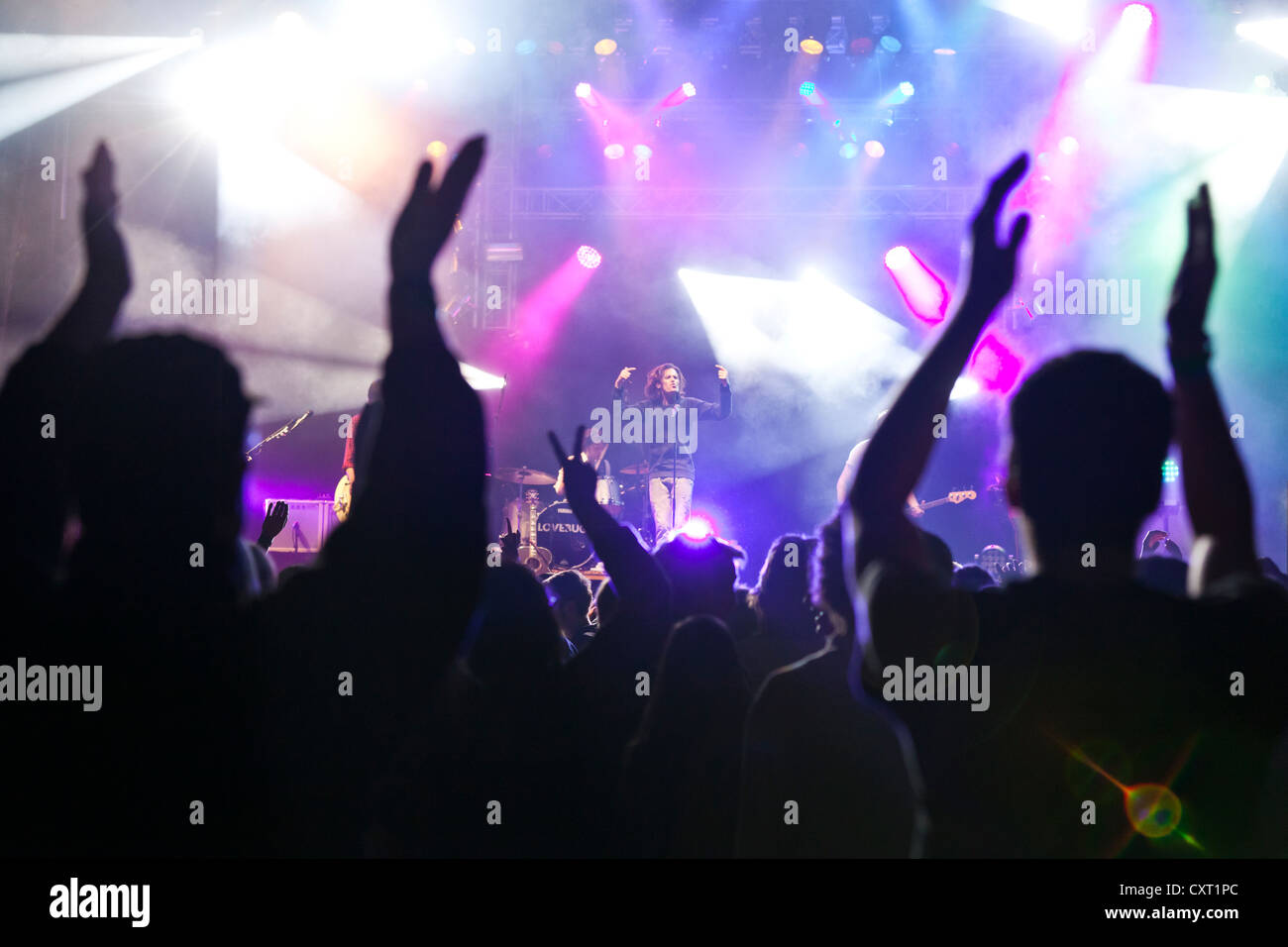 Visitors of the open-air festival cheering for the Swiss pop band ...