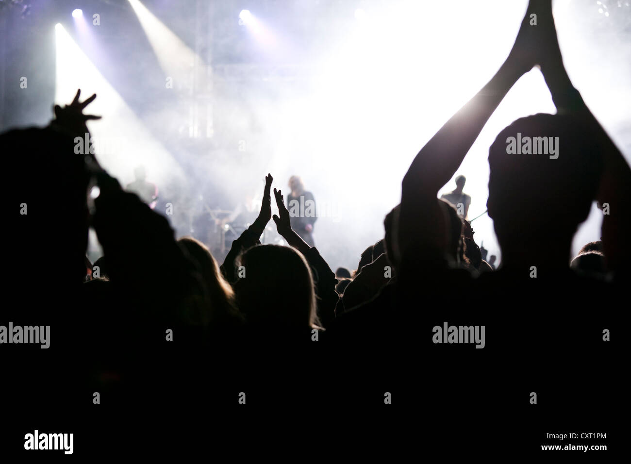 Visitors of the open-air festival cheering for the Swiss pop band ...