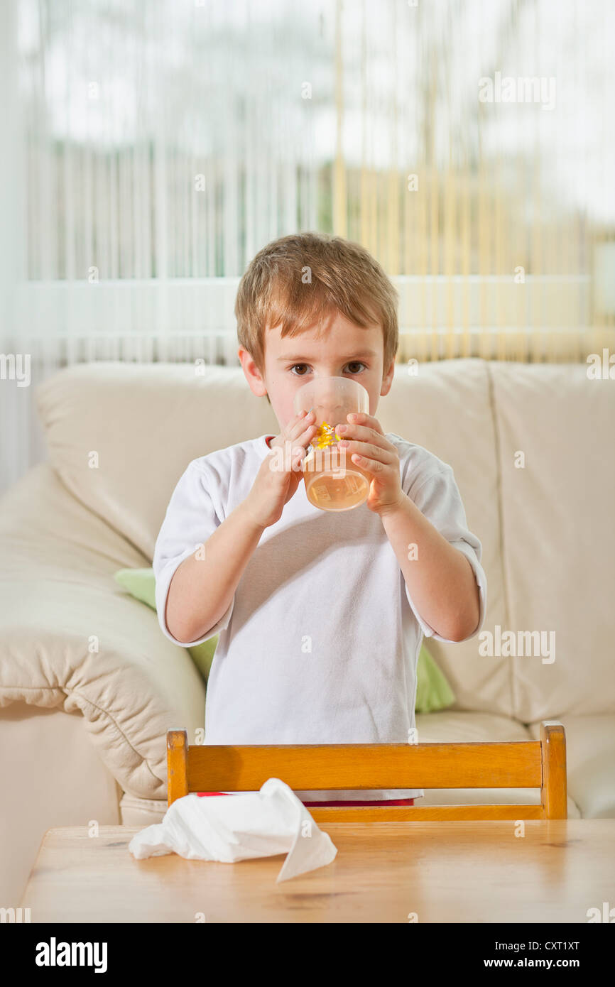 Boy drinking in the living room Stock Photo - Alamy