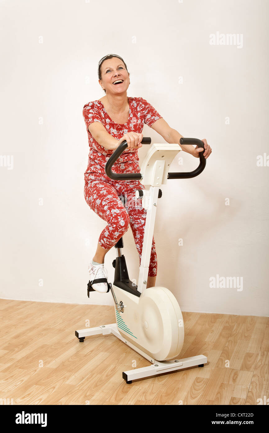 Woman working out on an exercise bike Stock Photo - Alamy