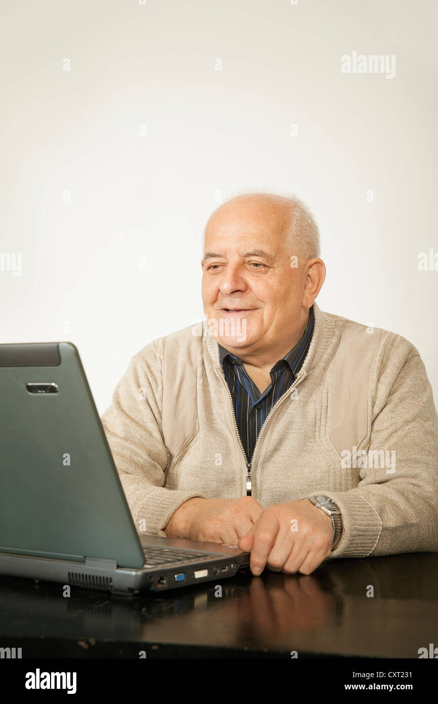 Old man sitting in front of a laptop Stock Photo - Alamy