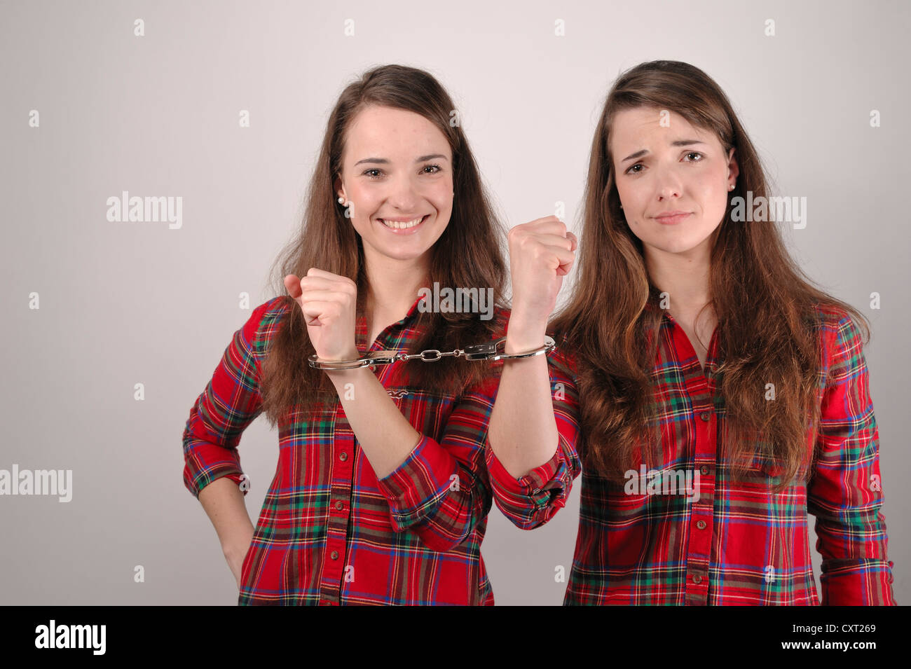 Twin sisters chained together handcuffs hi-res stock photography and ...