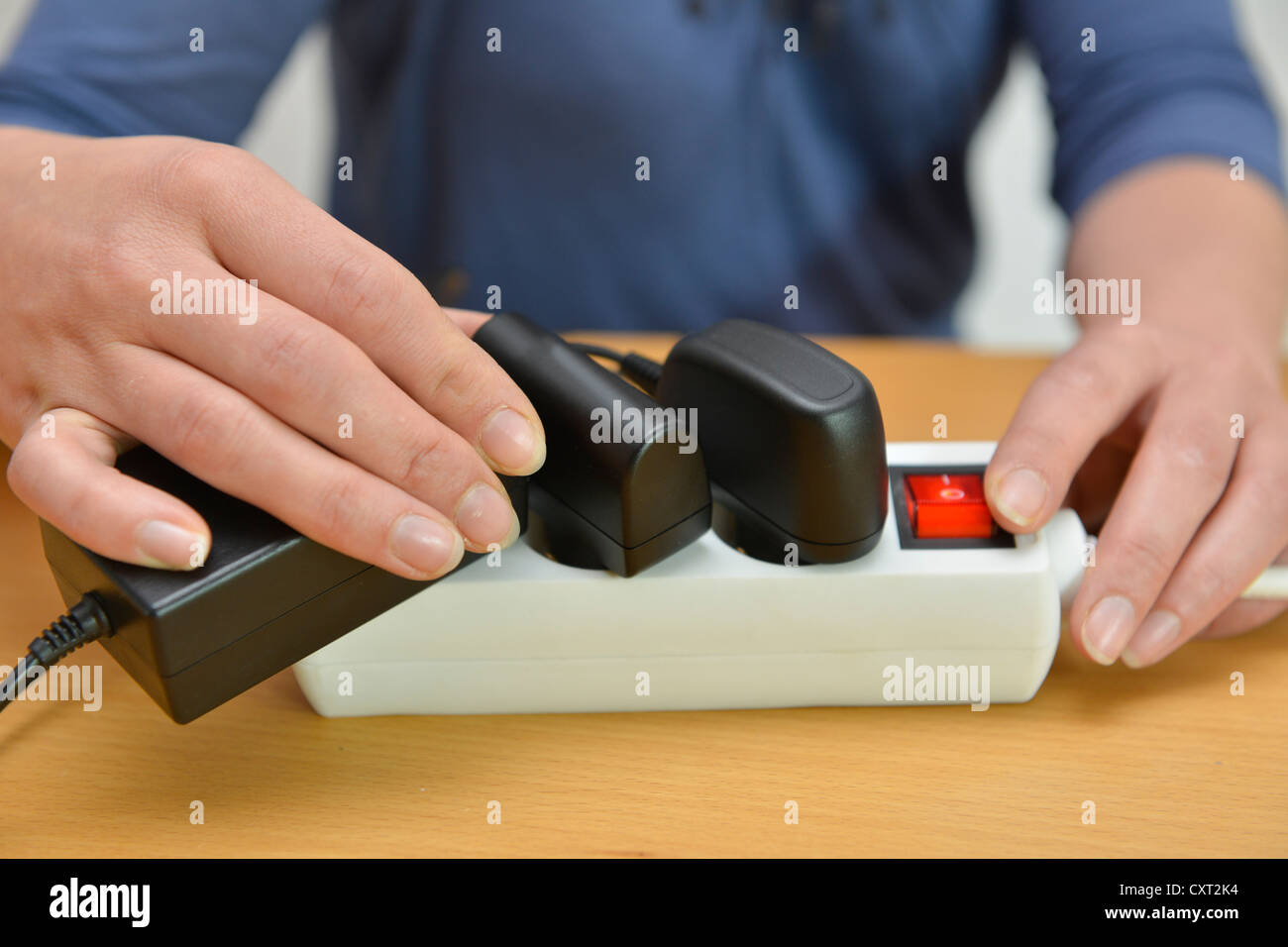 Woman putting a power adapter in a switchable power outlet Stock Photo ...