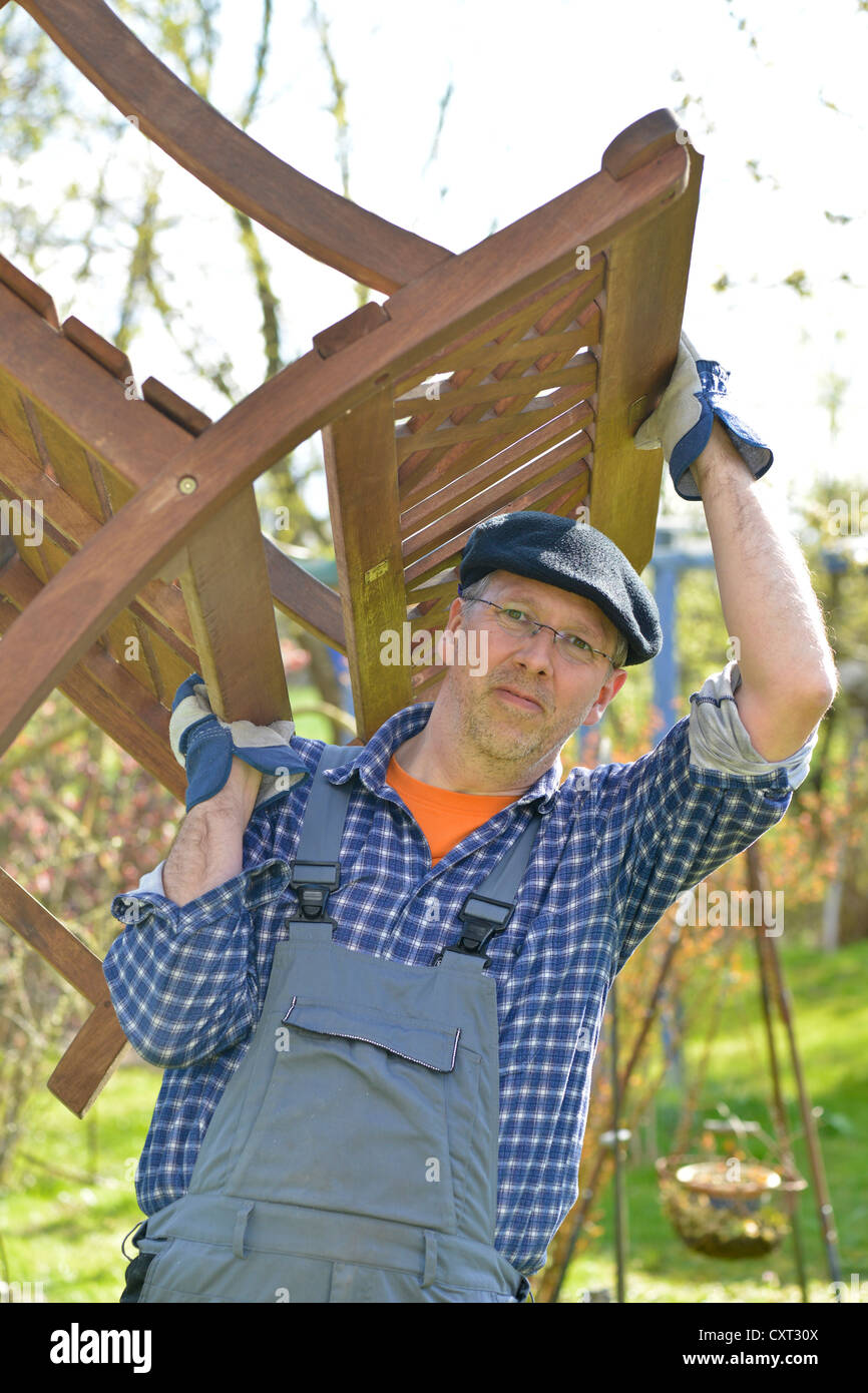 Man carrying a heavy bench Stock Photo - Alamy