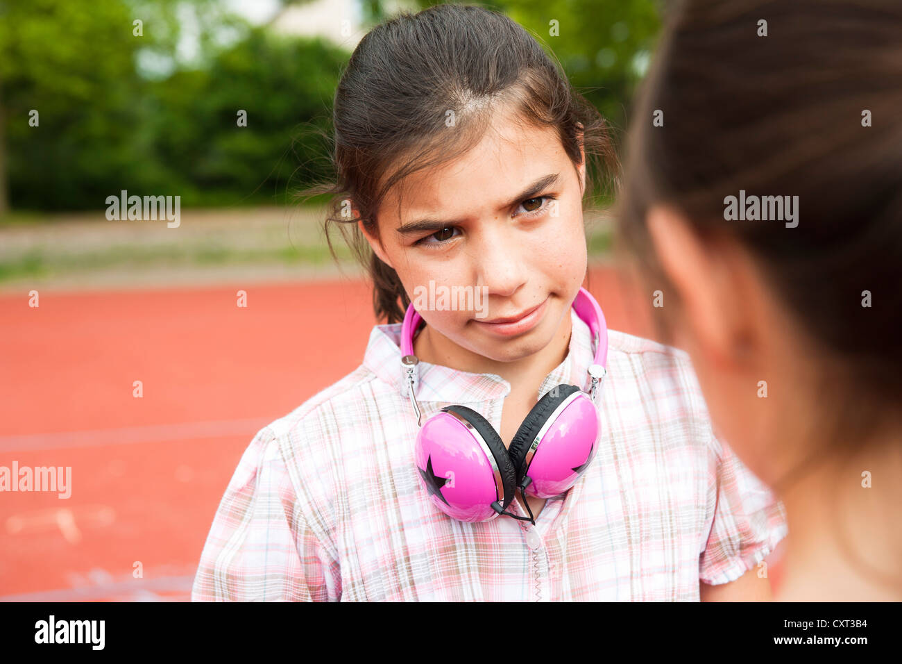 Girl looking angrily towards her friend Stock Photo - Alamy