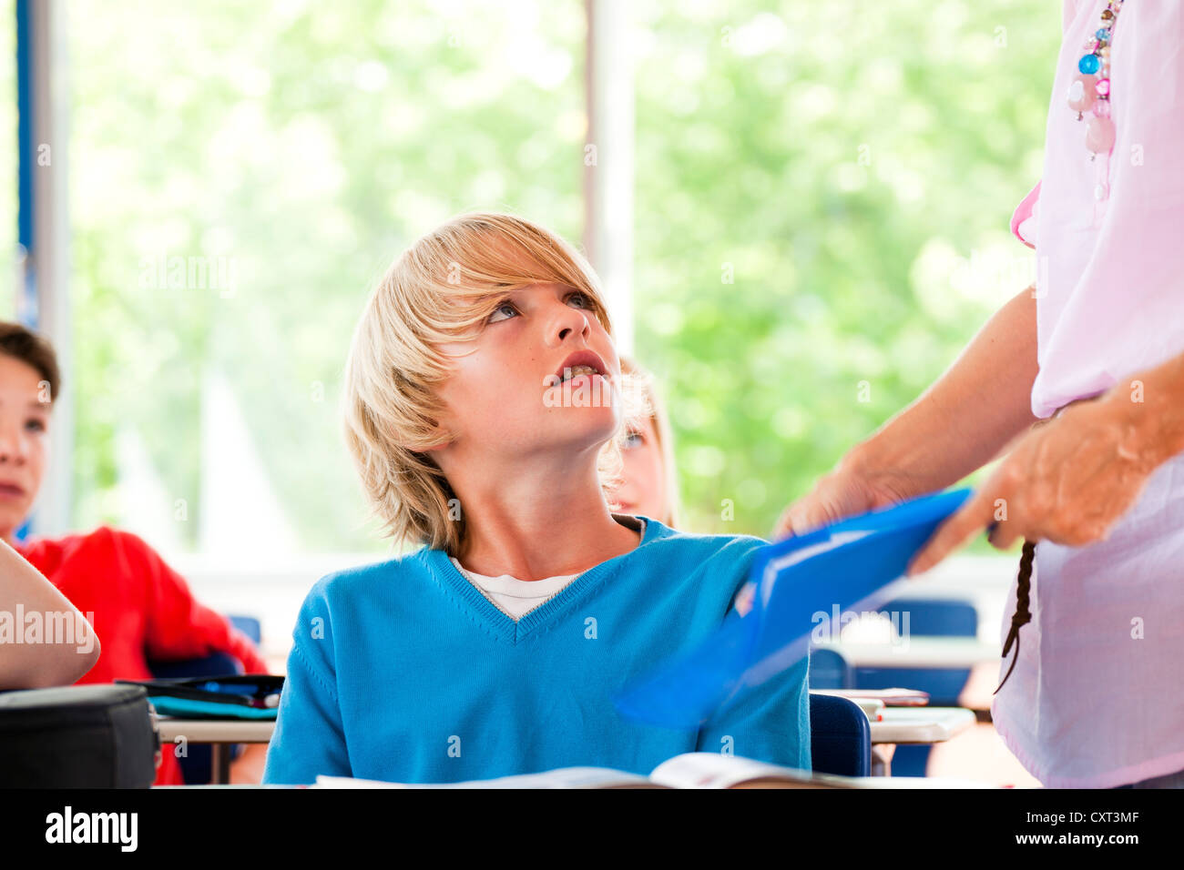 Schoolboy getting back a test Stock Photo - Alamy
