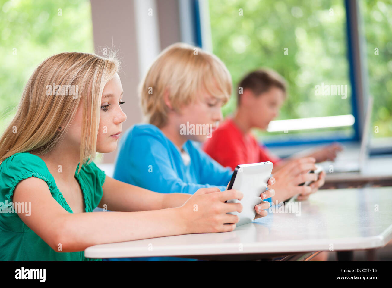 Group of schoolchildren working with computers in a classroom Stock ...