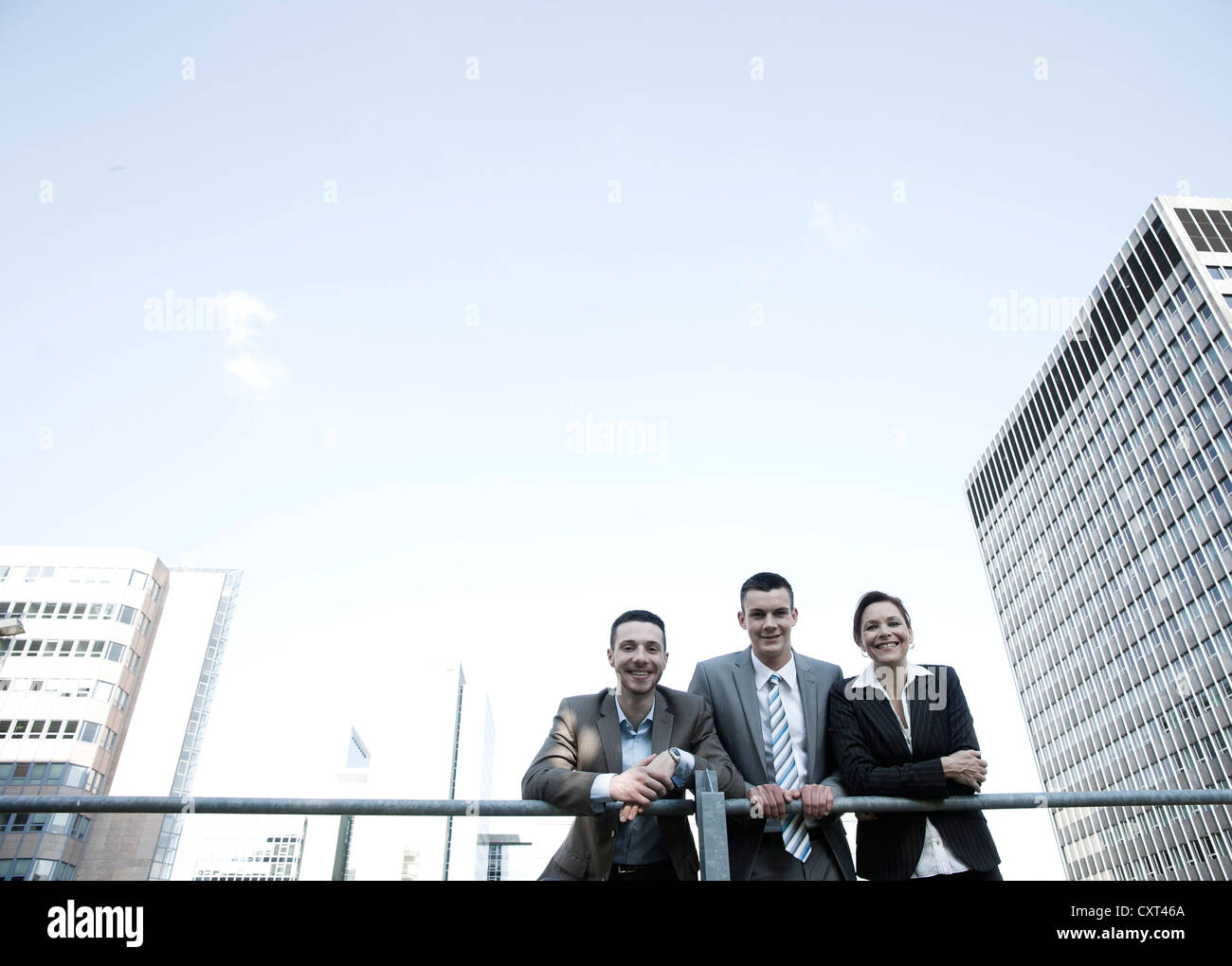 Group of business people in front of tall buildings Stock Photo - Alamy