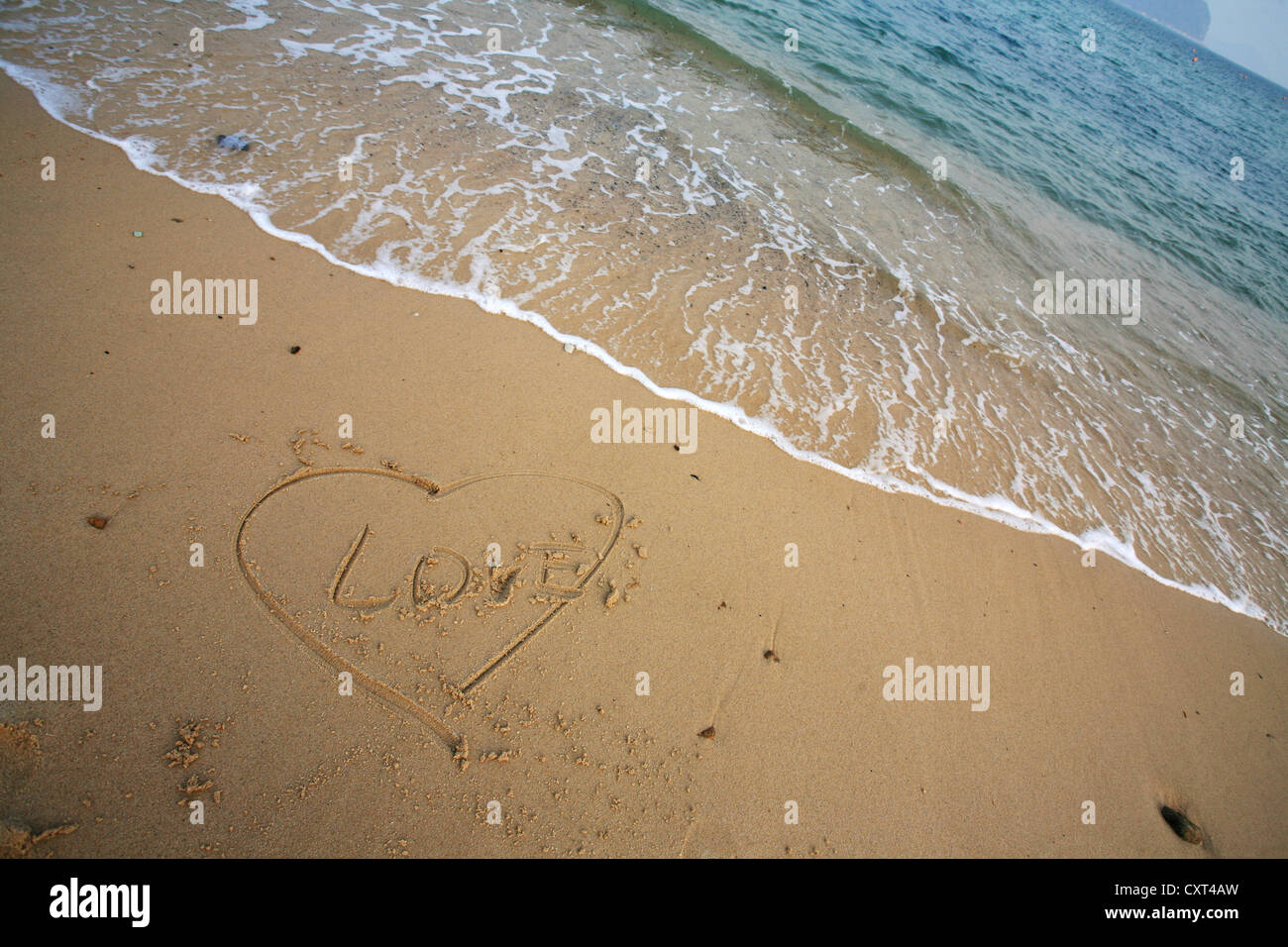 Love written in the sand hi-res stock photography and images - Alamy
