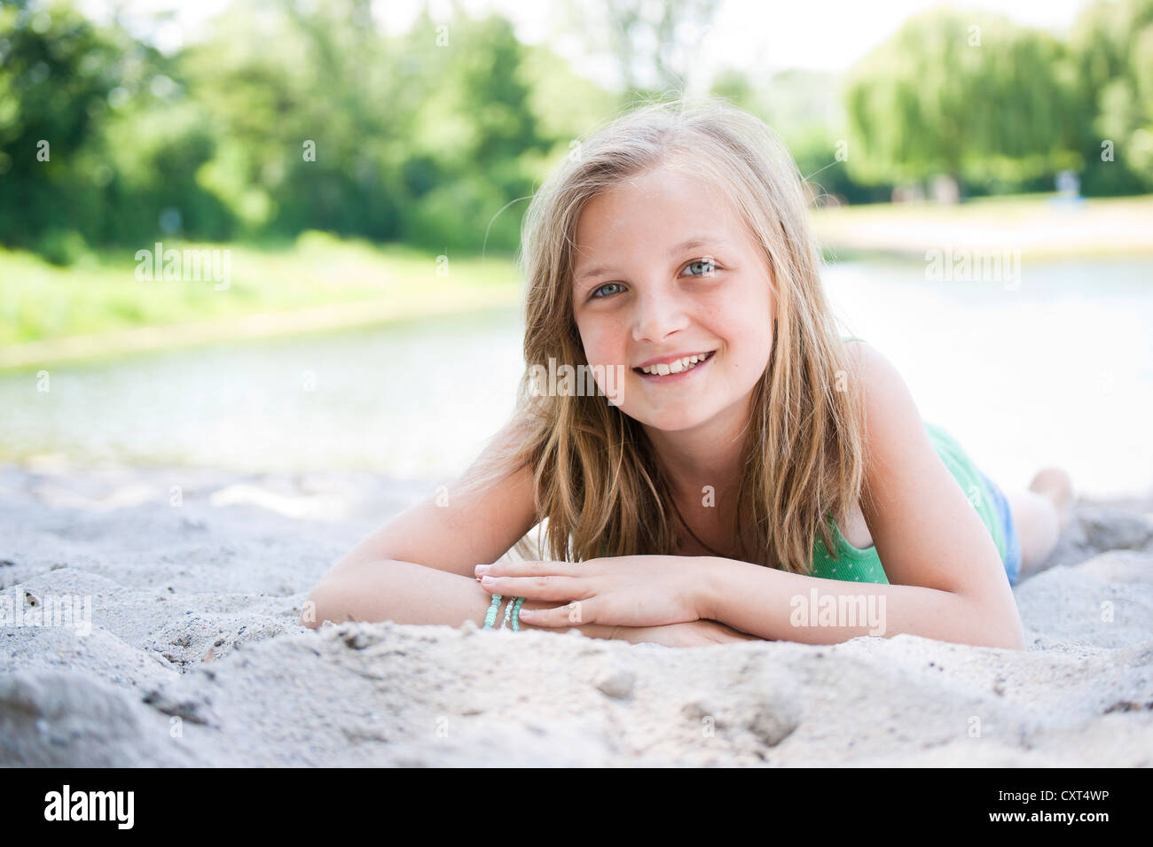 Young woman lying at waterside hi-res stock photography and images - Alamy