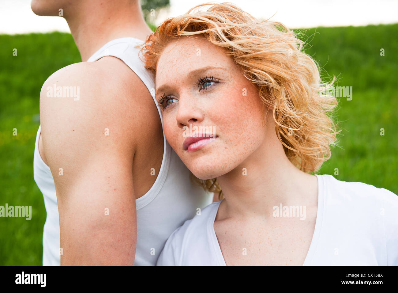 Young woman leaning against her partner Stock Photo - Alamy