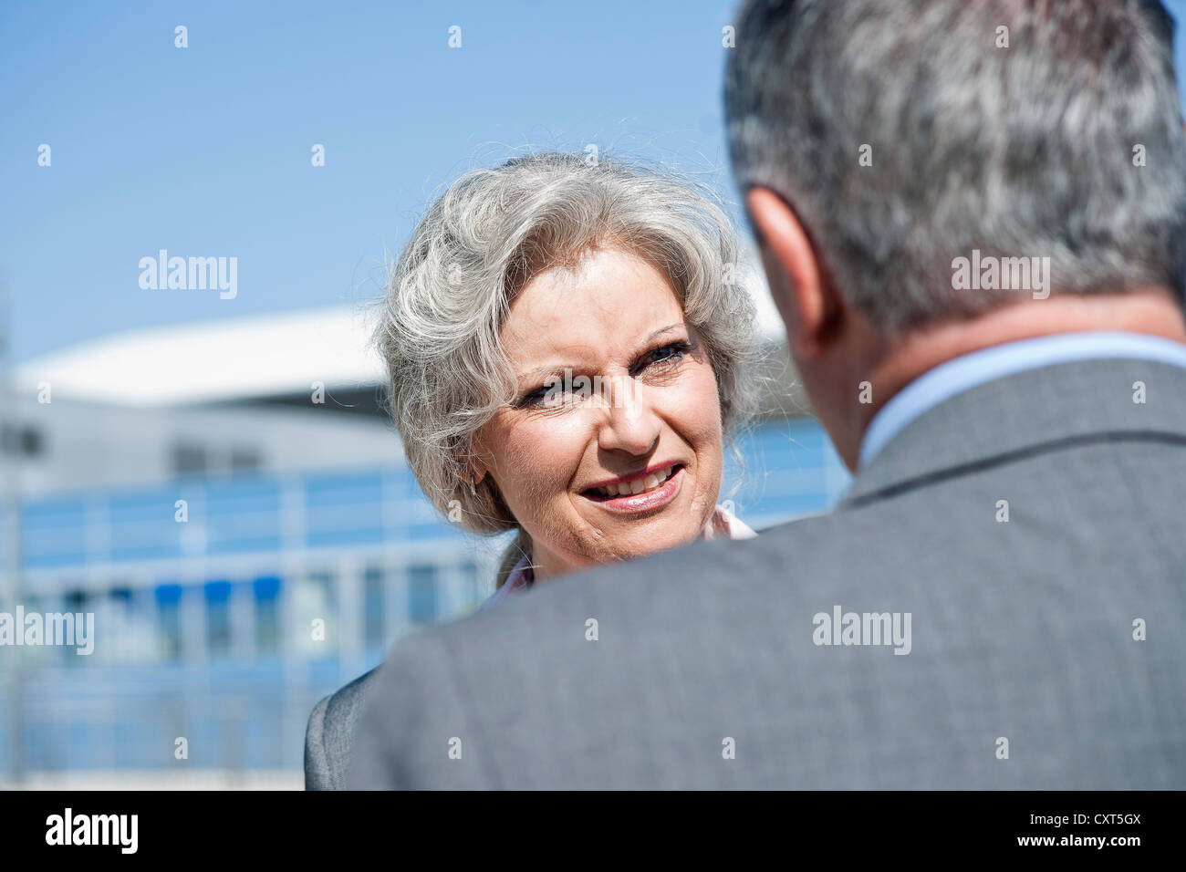 Businesswoman and a businessman having a conversation Stock Photo - Alamy