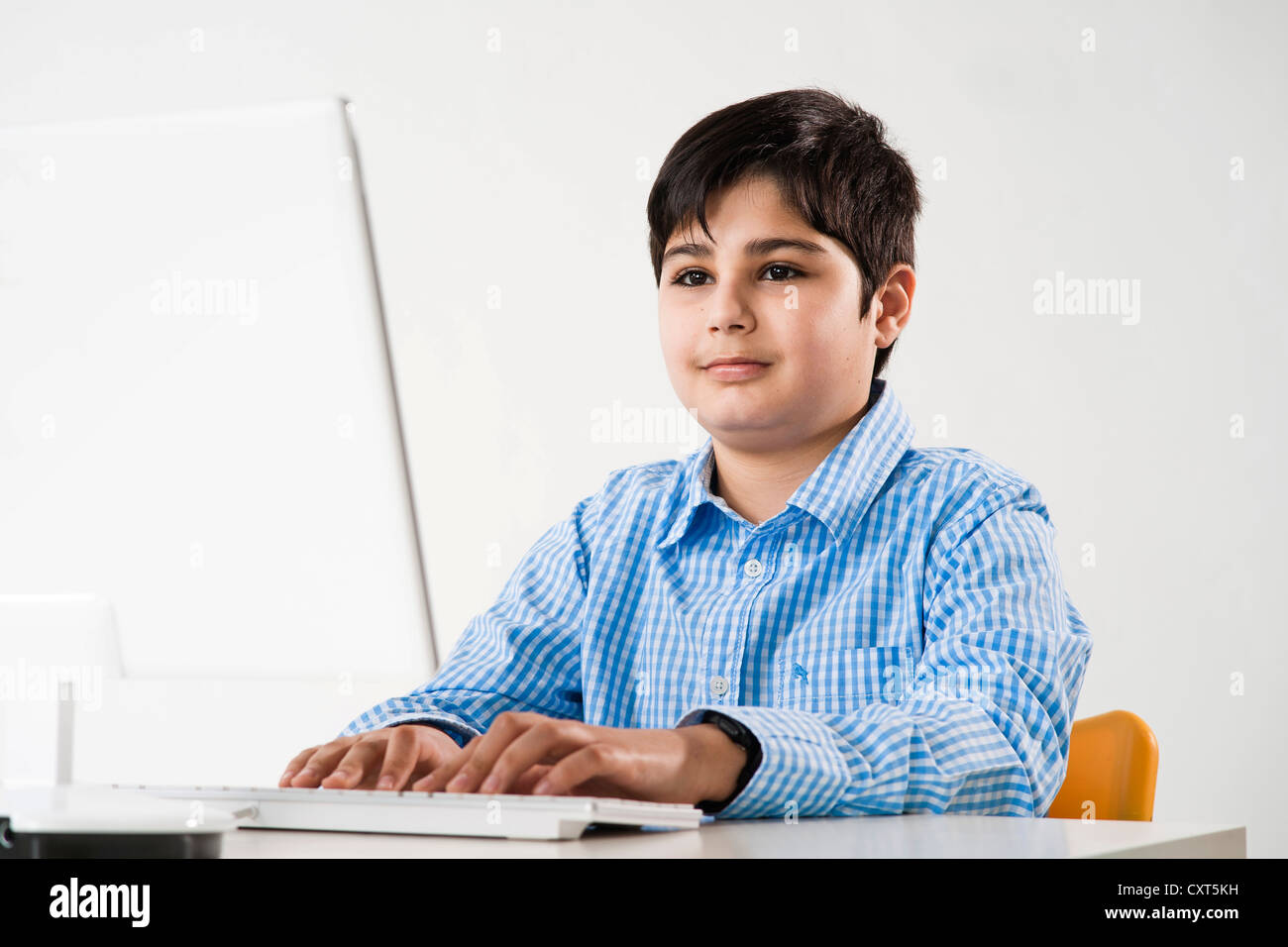Boy sitting at his computer Stock Photo - Alamy