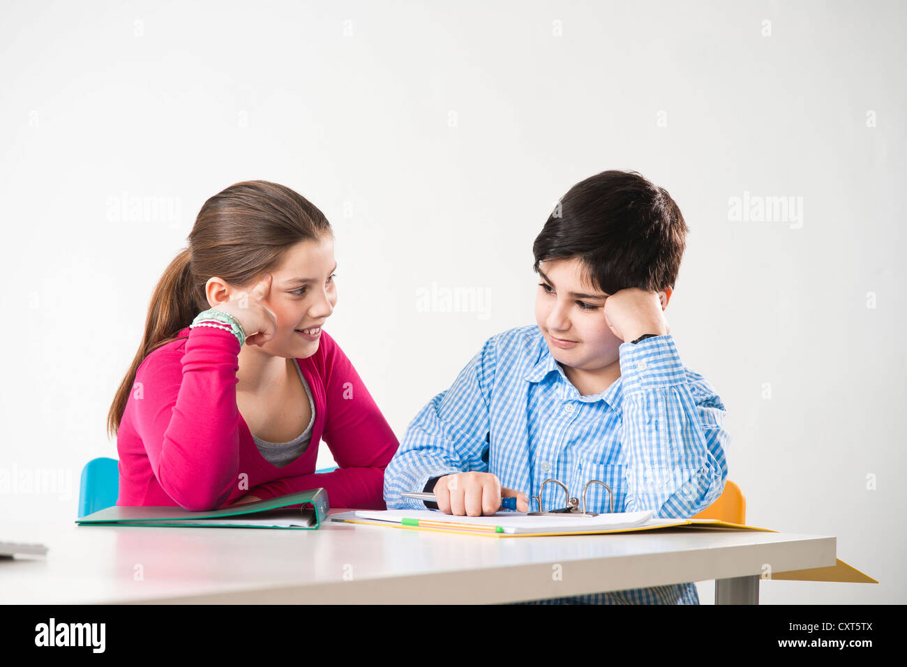 Boy and girl doing their homework together Stock Photo - Alamy