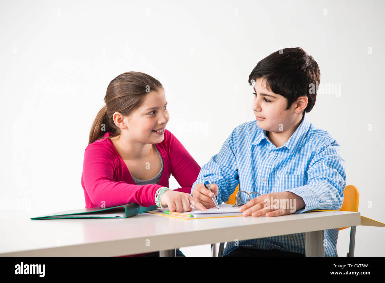 Girl helping boy with his homework Stock Photo - Alamy