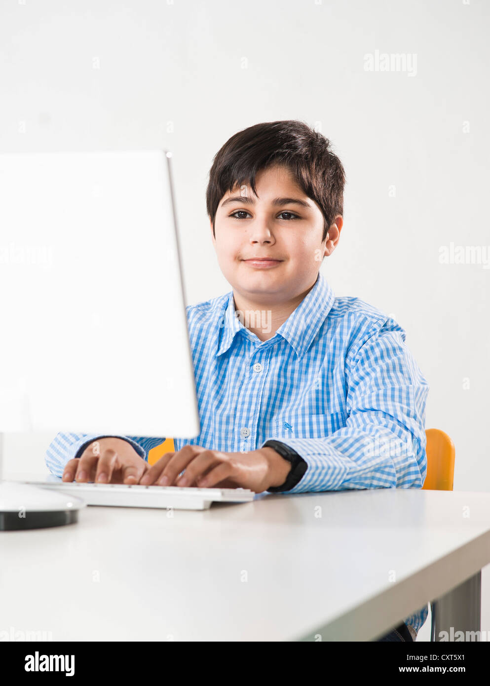 Boy sitting at his computer Stock Photo - Alamy