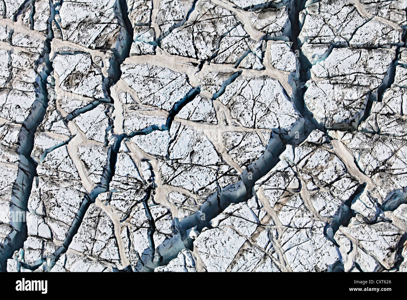 Aerial view, ice crevices and structures of volcanic ash and black lava ...