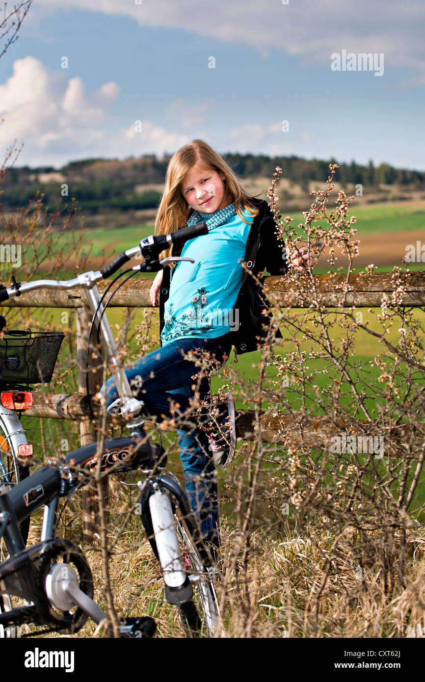 Girl with her bicycle in front of rural landscape Stock Photo - Alamy