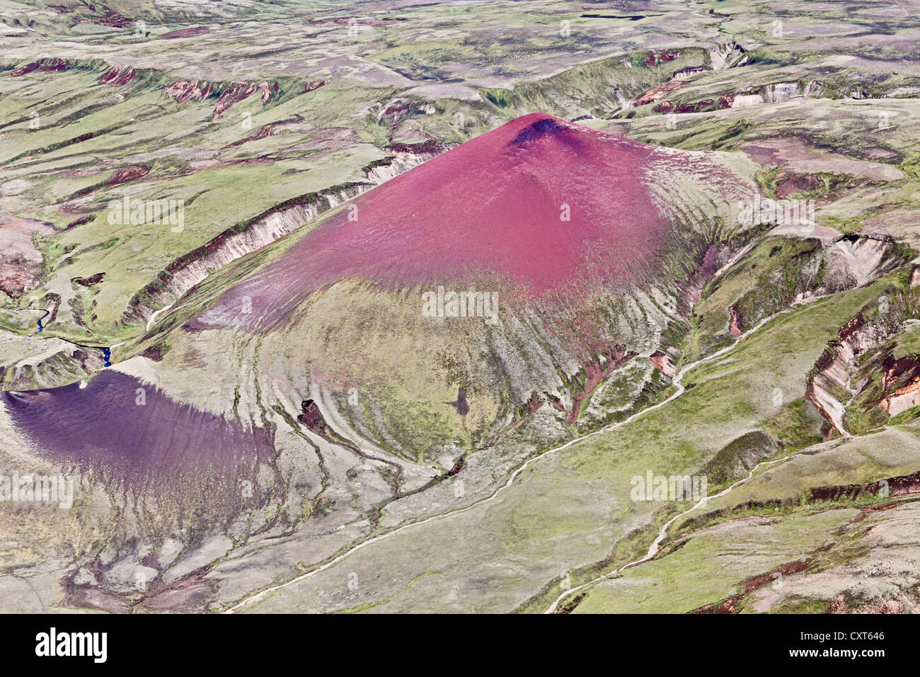 Aerial view, a bright red rhyolite mountain surrounded by the moss ...