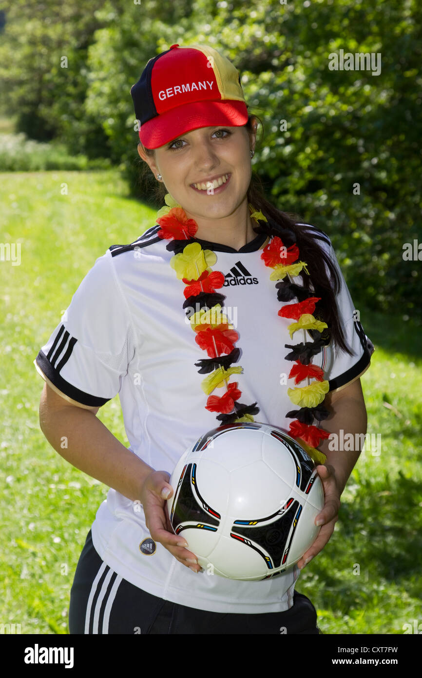 Young woman, football fan wearing a Germany cap and jersey, portrait ...