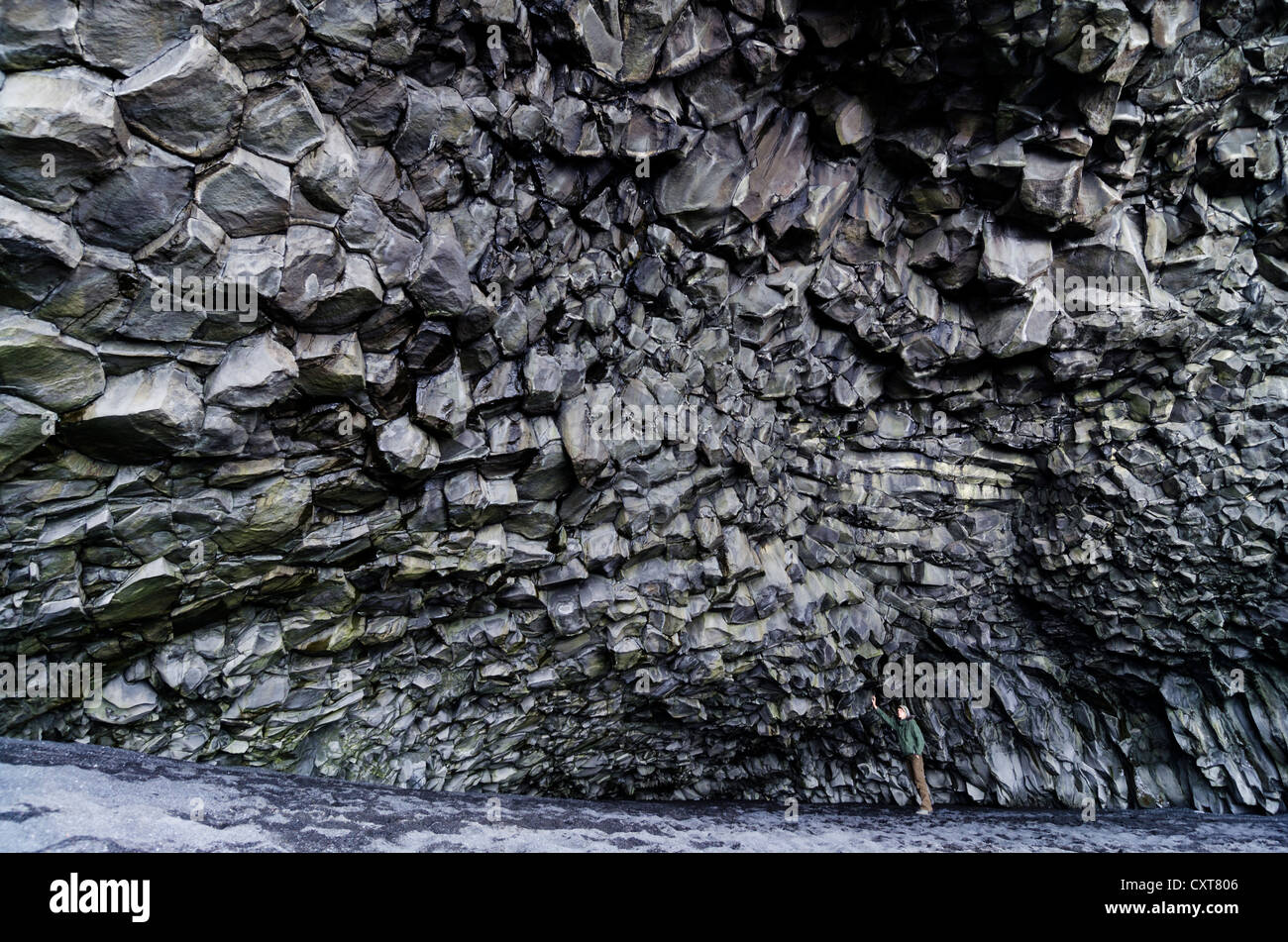 Woman in Hálsanefshellir cave with basalt formations, Reynisfjara beach ...