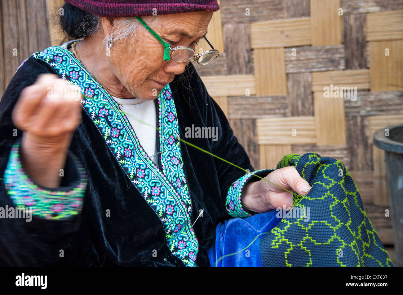 Elderly, traditionally dressed woman with glasses from the Black Hmong ...