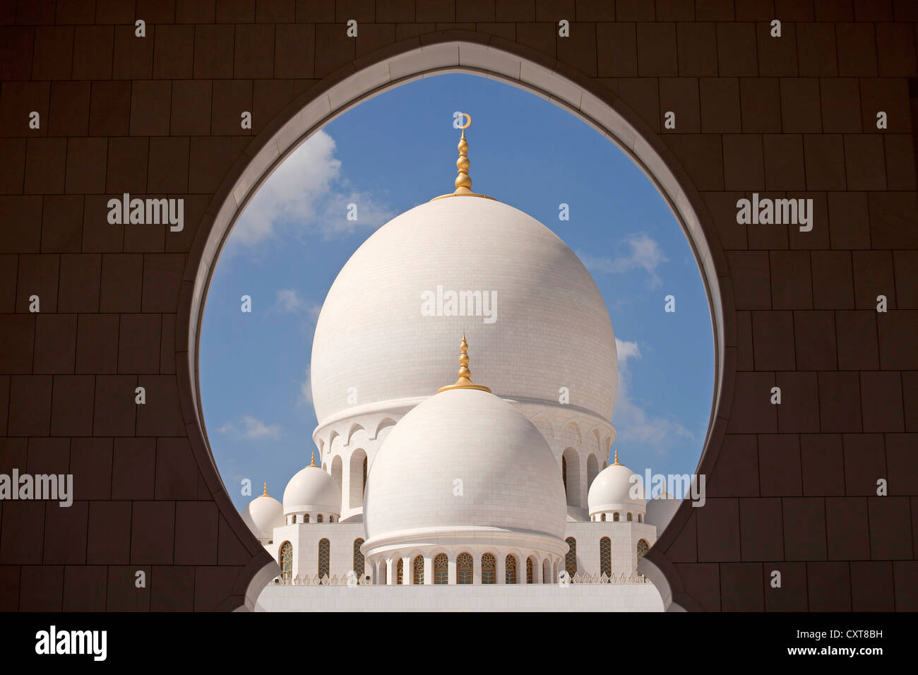 View through a round window towards the domes of Sheikh Zayed Mosque in ...